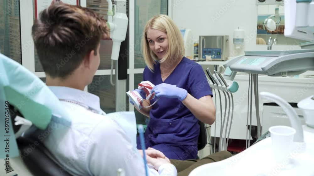 Female dentist holding consultation in the office. Dentist telling the ...