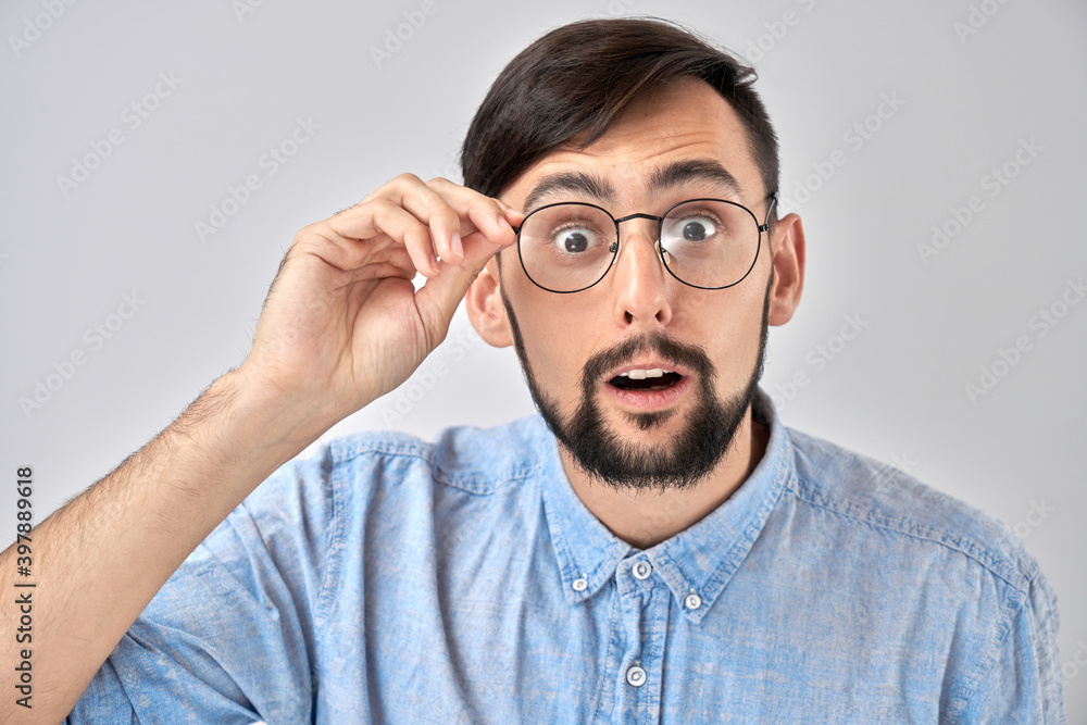 OMG! Wow! Studio shot caucasian bearded shocked man with bulging eyes ...