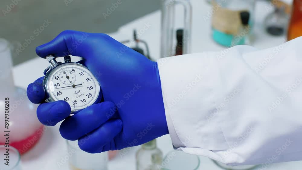 Details closeup in a biotechnology lab man doing a chemical reaction ...