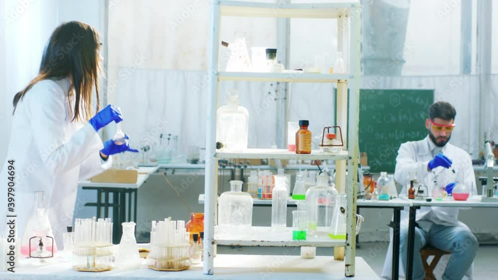In the chemistry laboratory two scientist man and woman together ...