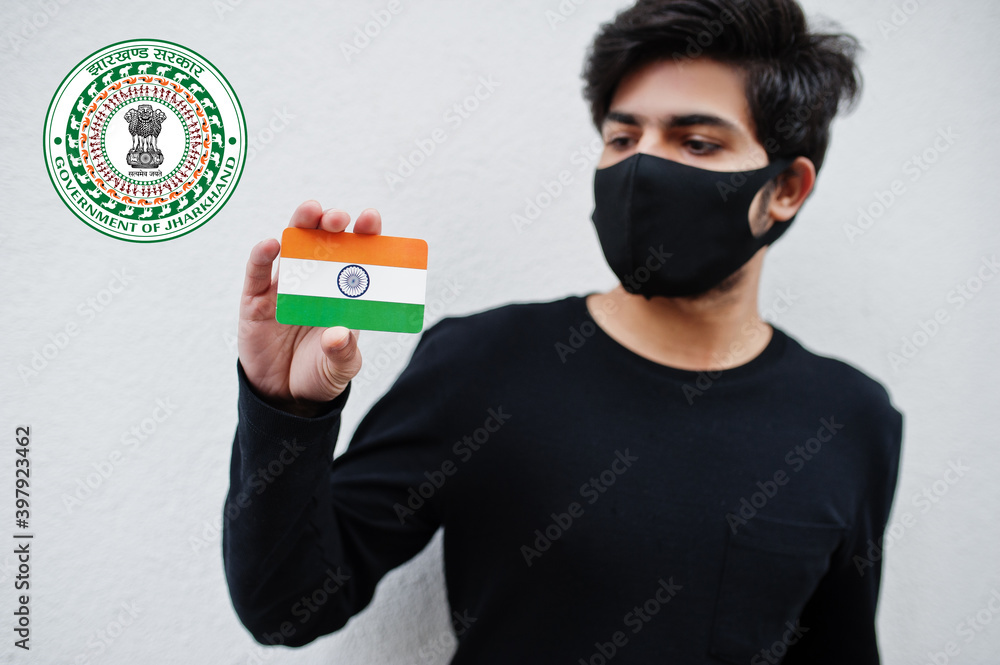 Indian man wear all black and face mask, hold India flag in hand ...