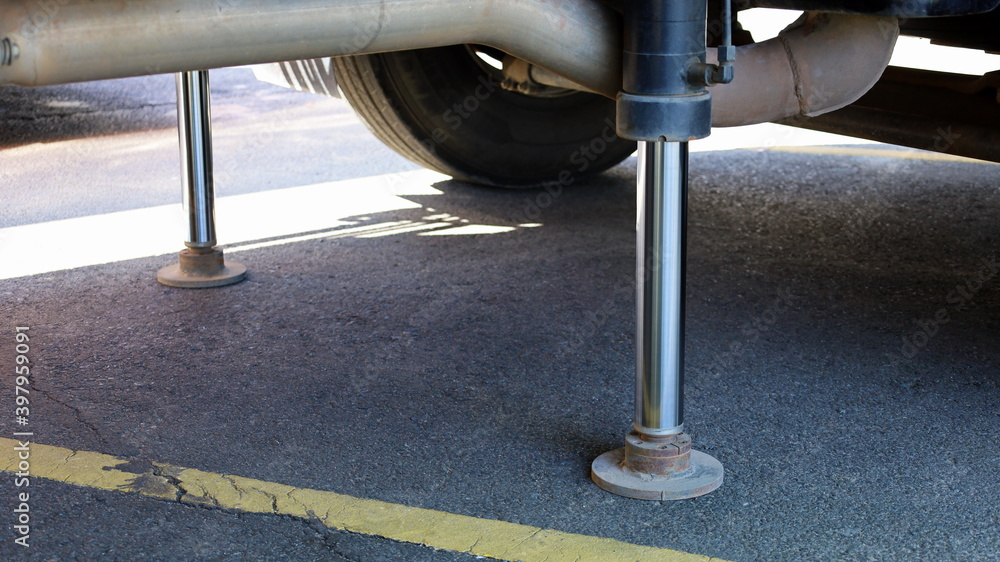 Hydraulic supports of trucks. Telescopic hydraulic cranes are placed on ...