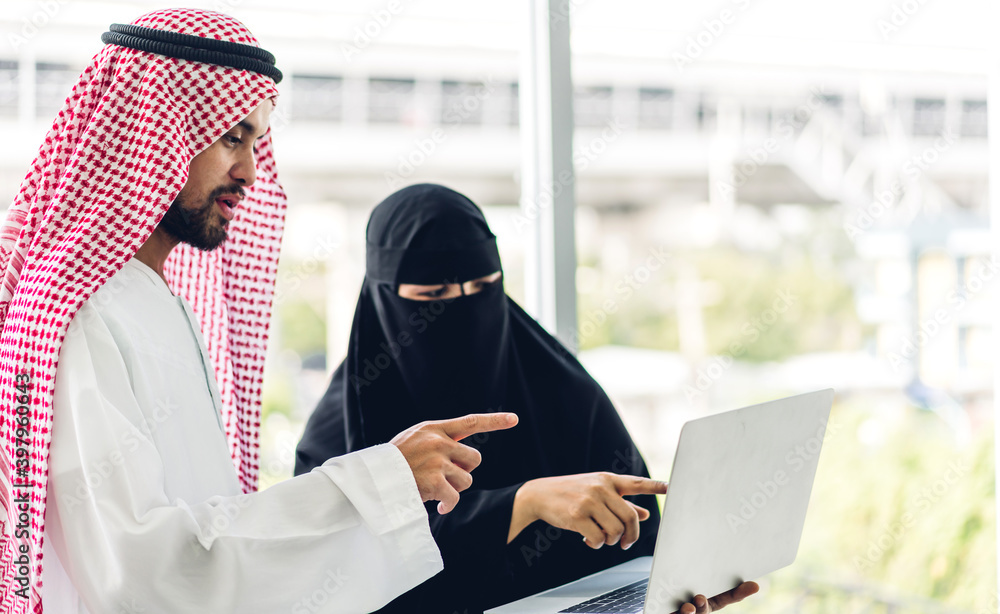 Successful of two arabic business people working with laptop computer ...