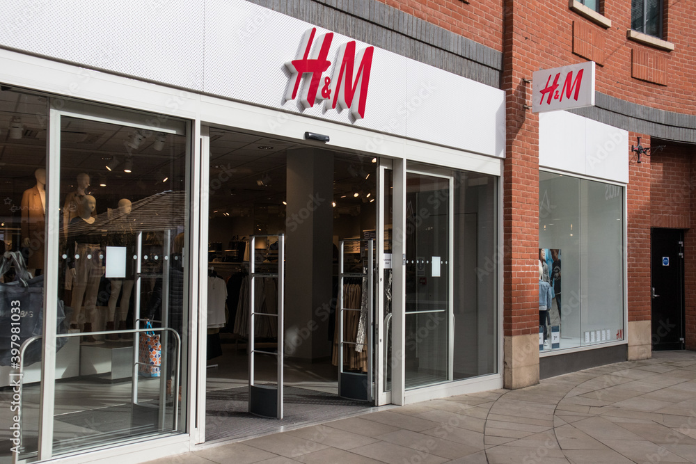 Entrance to H & M Fashion clothing store shop showing logo, sign ...