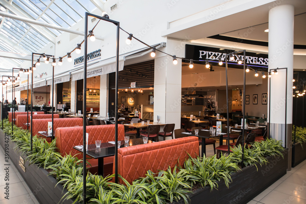Public food court eating area inside shopping mall centre. Pizza ...