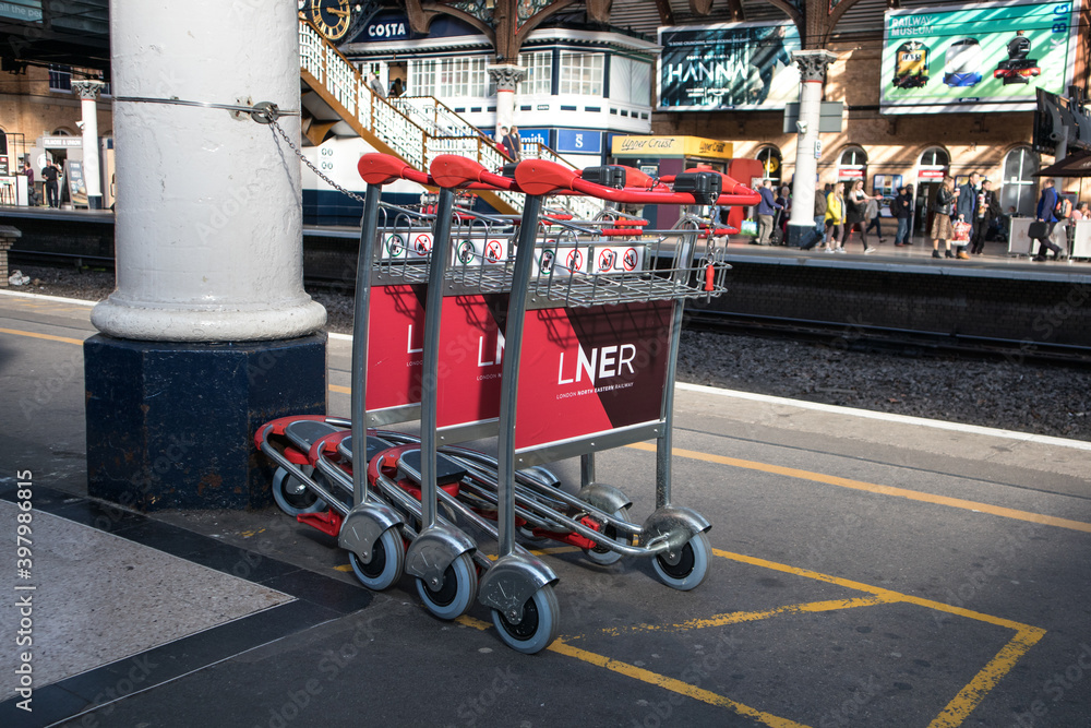 LNER branded railway station trolleys on a platform ready for use ...