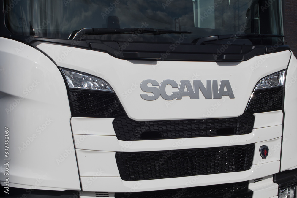 Front of brand new Scania truck in white showing company logo, radiator ...