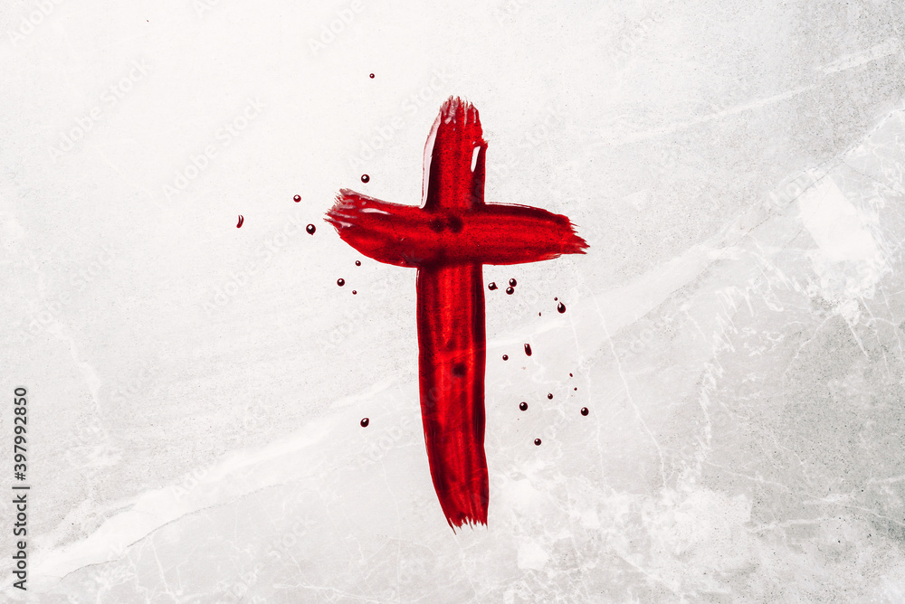 Christian cross painted with red blood on stone background. Copy space ...