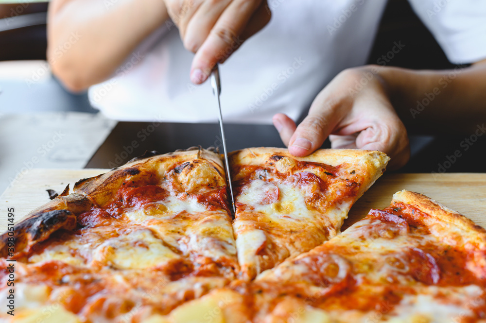 Wood fire cheesy pizza slice in hand. Traditional Hawaiian and Salami ...