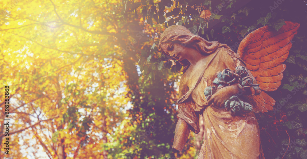 Fragment of ancient stone statue of beautiful guardian angel in sun ...