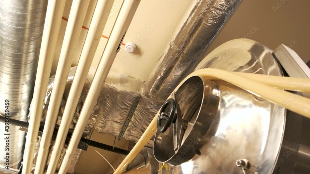 Ventilation pipes and tubes hanging on ceiling. Ducts installed on ...