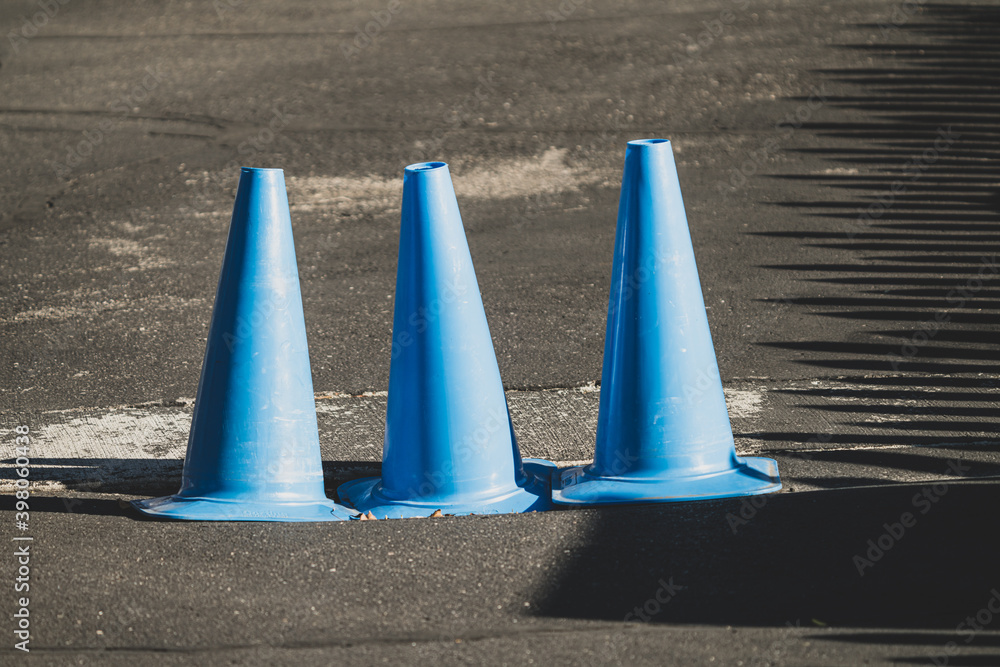blue safety cones are blocking a trip hazard on the path ahead of you ...