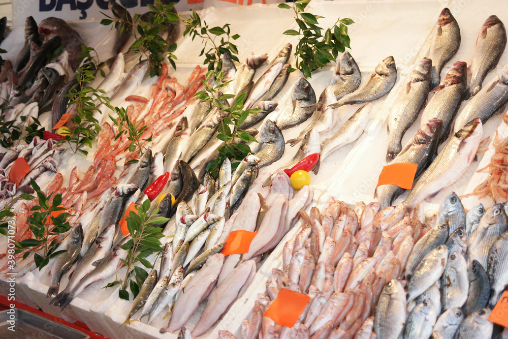 Assorted raw fish on display at fish market. Market stall with various ...