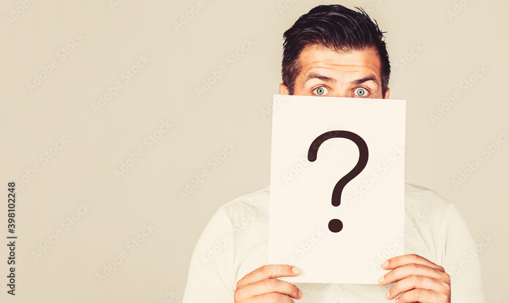Man a question. Doubtful man holding Question Mark. Problems and ...