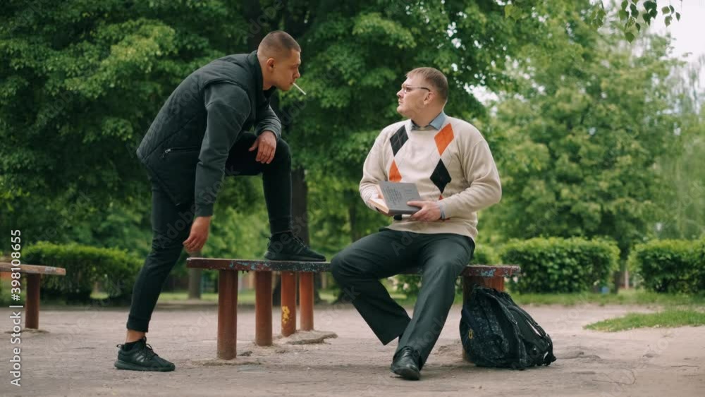 Cruel teenager pushing nerd man, threatening physical harm, bullying.A ...