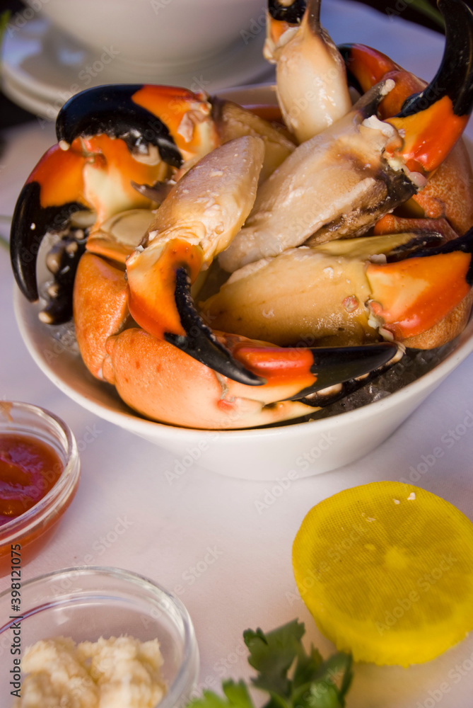 Stone crab claws. Colossal Crab claws served with lemons, spicy ...