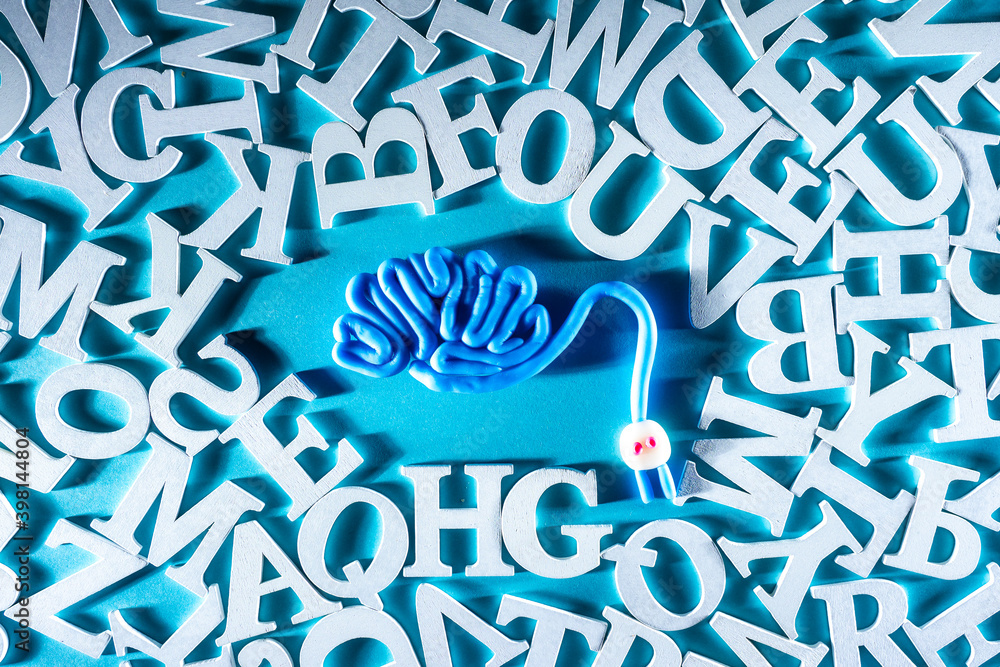 Wire is located in shape of a human brain. Chaotic letters around brain ...