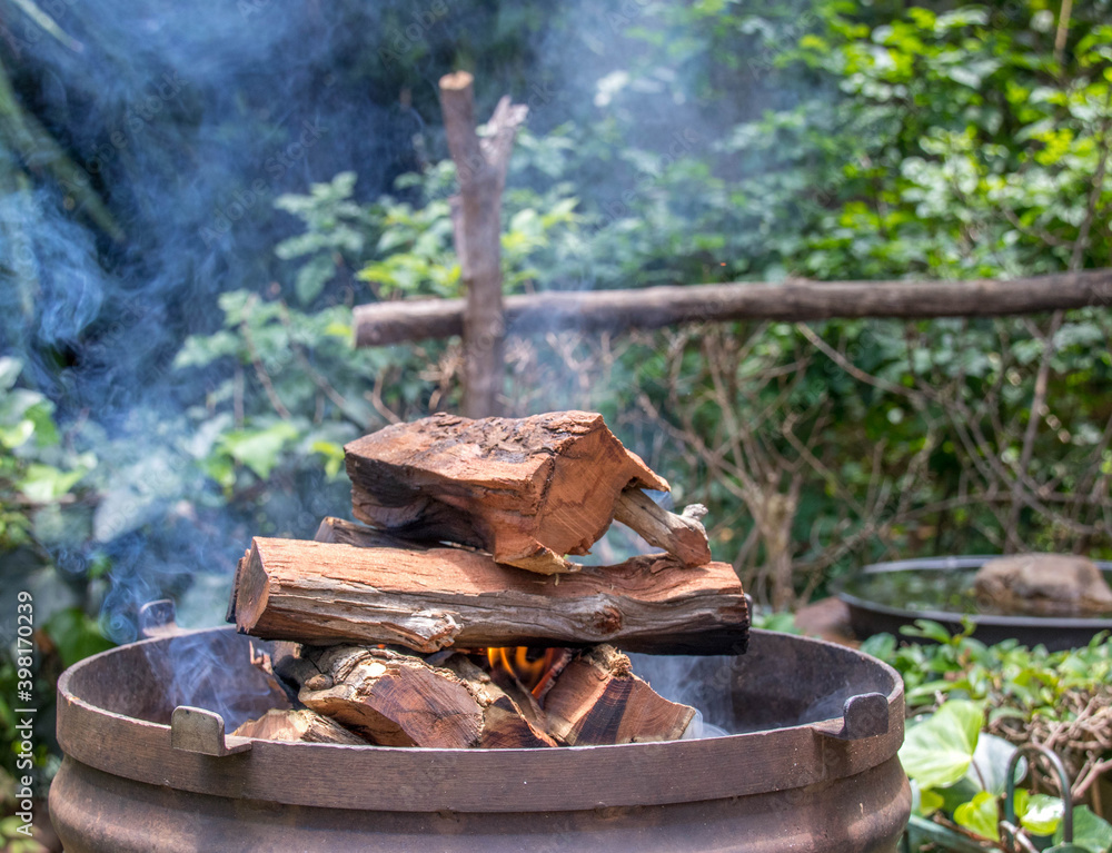 A wood fire to prepare coals for a traditional South African outdoor ...