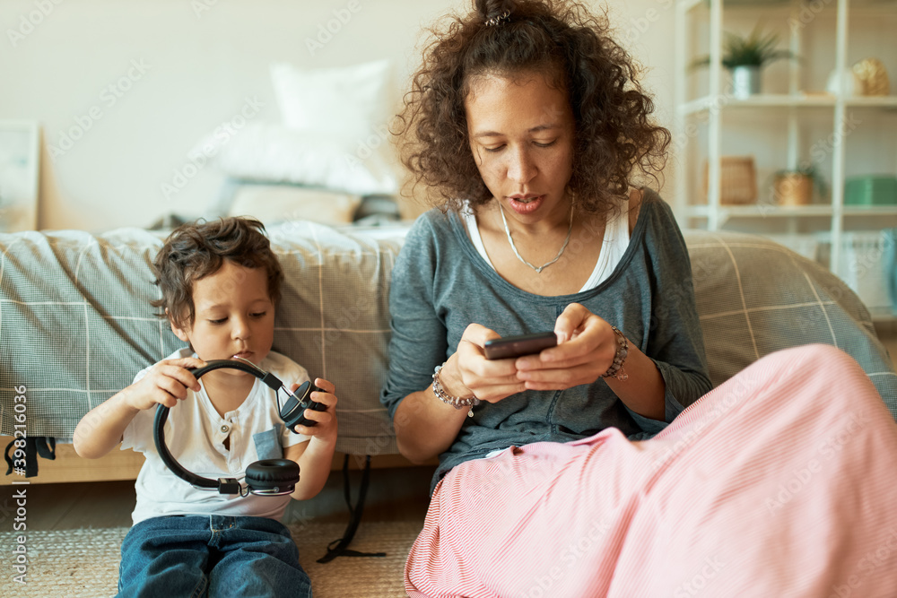 People, children, technology and electronic gadgets. Young mixed race ...