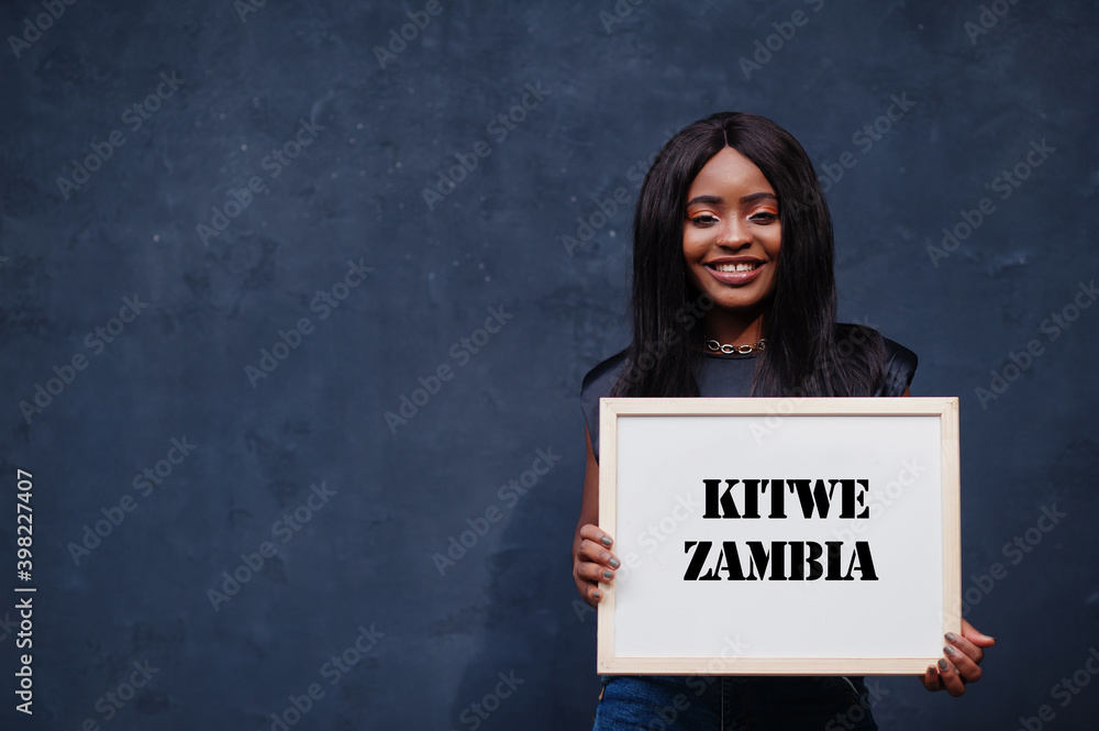 Foto de African woman hold white board with Kitwe Zambia inscription ...