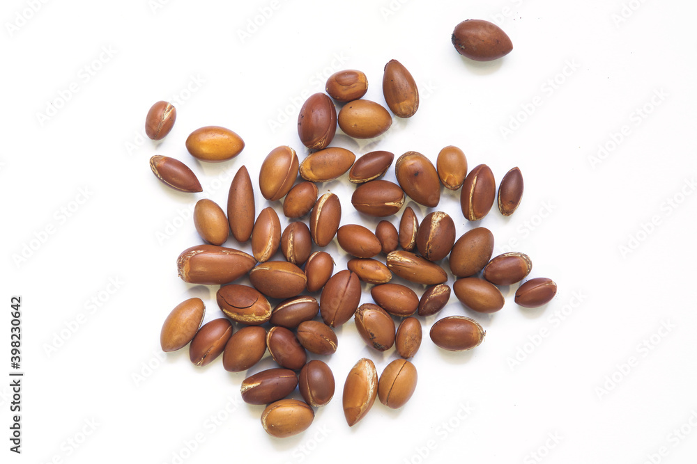 the nuts of the argan tree Argania spinosa on a white background. For ...