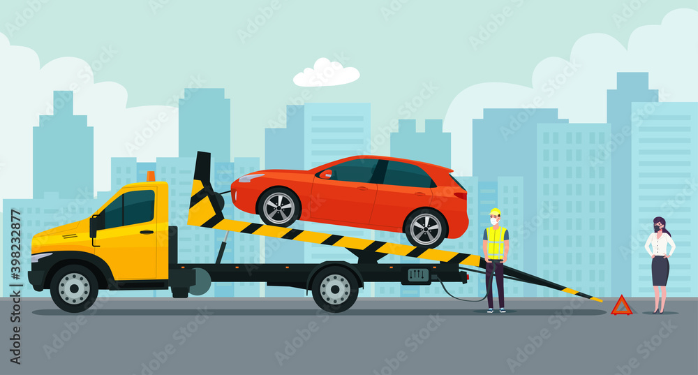 The driver in medical mask of the tow truck is loading the faulty car ...