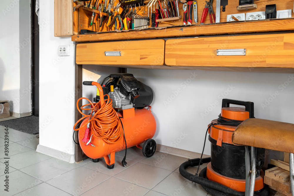 Orange small portable industrial power air compressor with coil hose ...