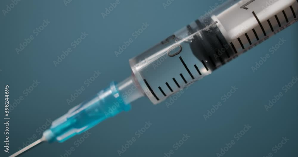 Close Up of Injection Liquid Being In Syringe Against Red Background ...