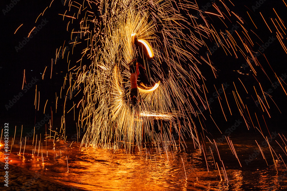 Fire-jugglers perform a show on beach, swing fire, fire show on the ...