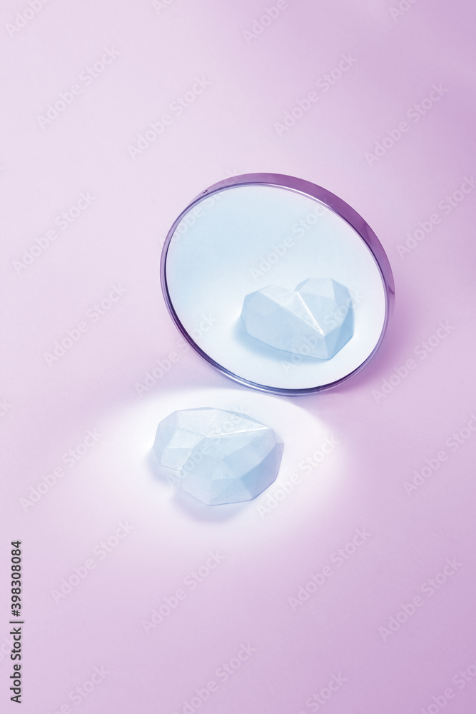 Reflection of blue plaster heart in a mirror. Stock Photo | Adobe Stock