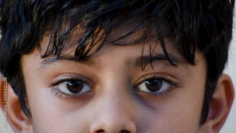 Close up of eyes of little Indian kid staring at the camera. Stock ...