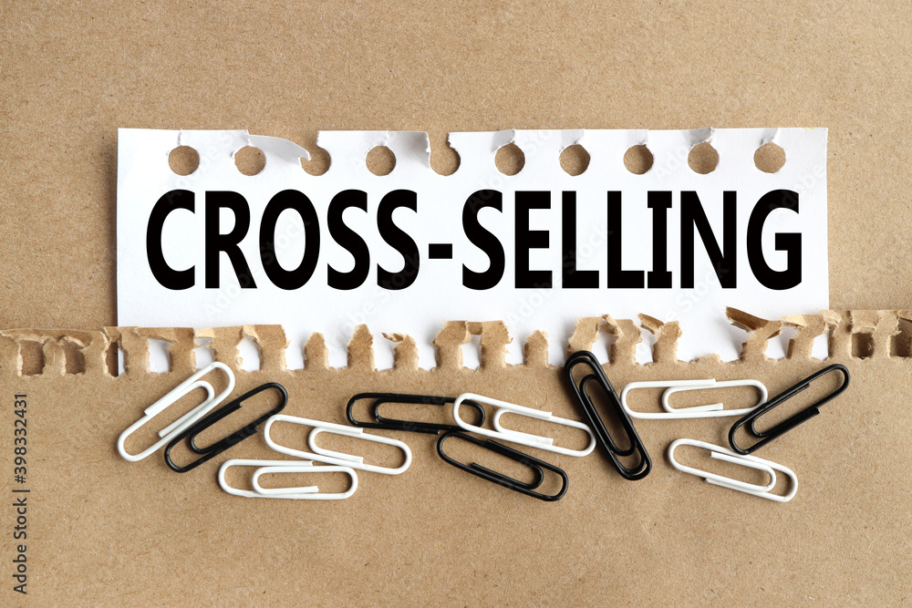 CROSS SELLING. word. text. on white paper on torn paper background ...