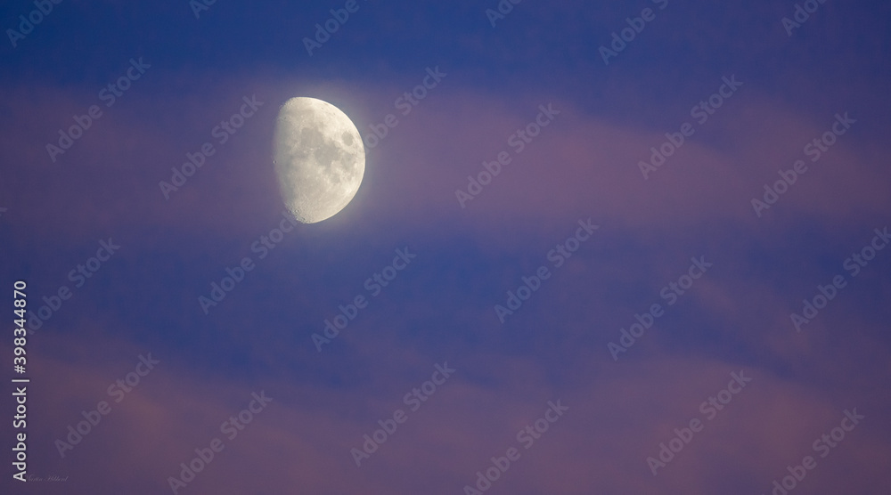 half moon in a vivd pink and purple twilight sky Stock Photo | Adobe Stock
