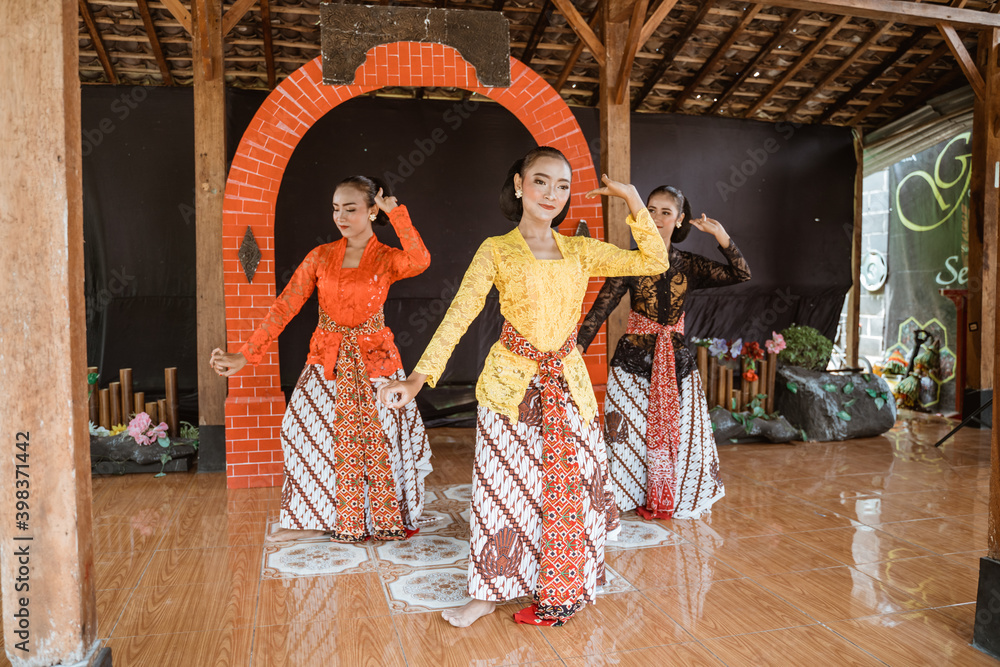 portrait of three young women presenting traditional Javanese dance ...