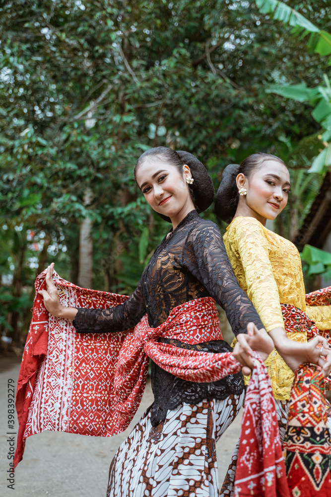 portrait young women presenting traditional Javanese dance movements ...