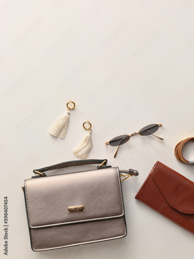 Stylish bag and accessories on light background Stock-Foto | Adobe Stock