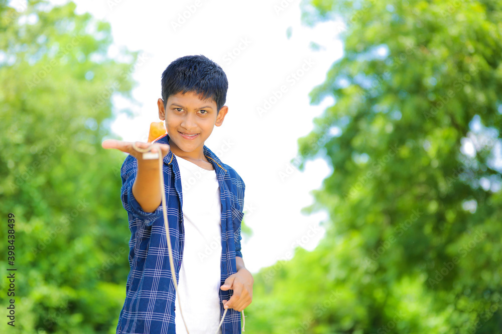 Cute indian little child playing Lattu, Bhovra or Bambaram is a ...