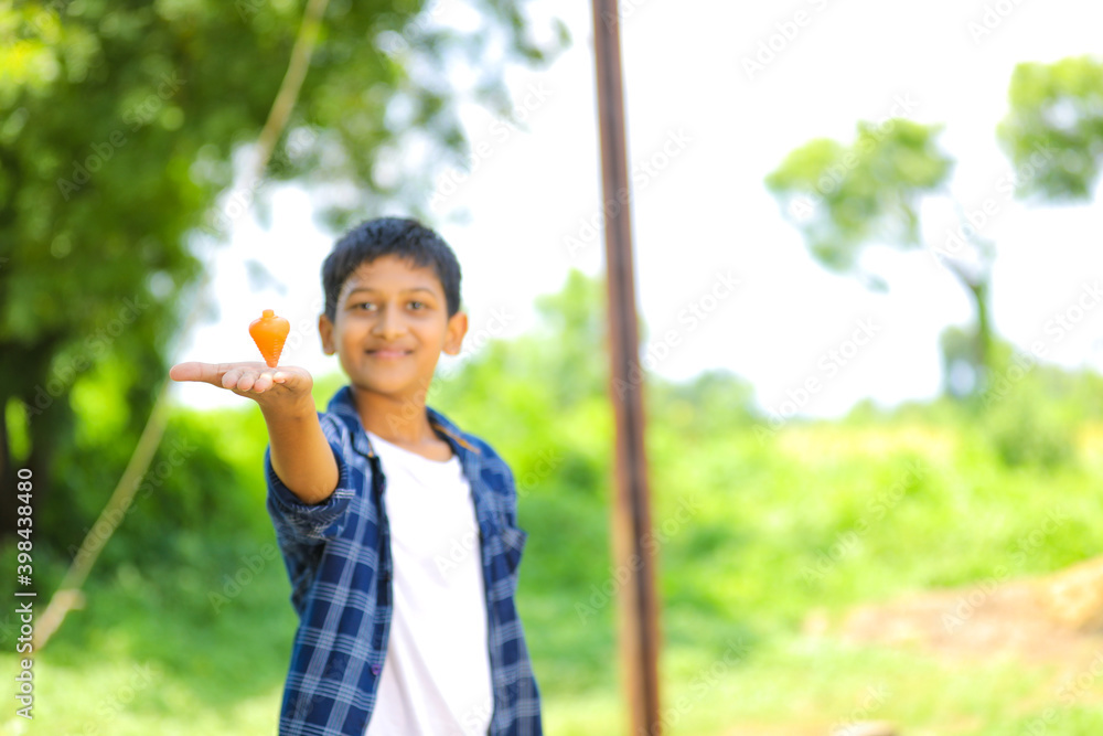 Cute indian little child playing Lattu, Bhovra or Bambaram is a ...