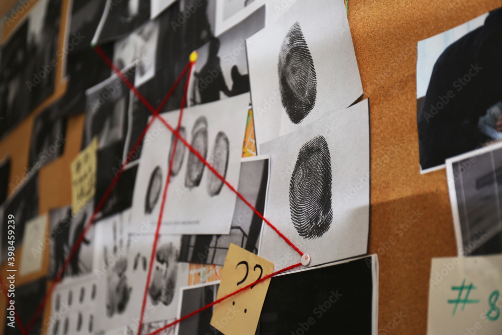 Detective board with crime scene photos, stickers, clues and red thread ...