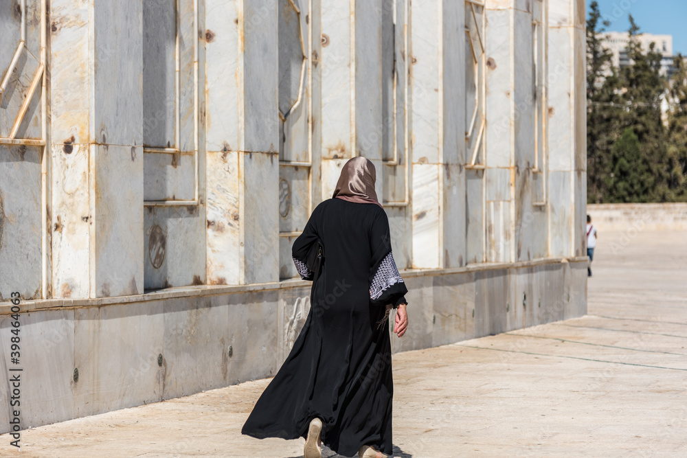 Muslim woman walking at the square of the Golden Dome of the Rock ...
