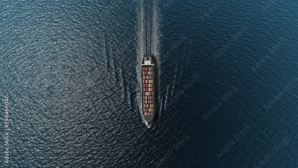 Cargo ship with containers in the open blue sea- Top down view ...