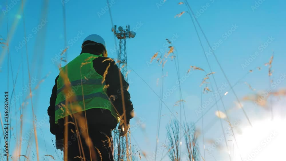 Silhouette engineer working on satellite dish telecom network on ...