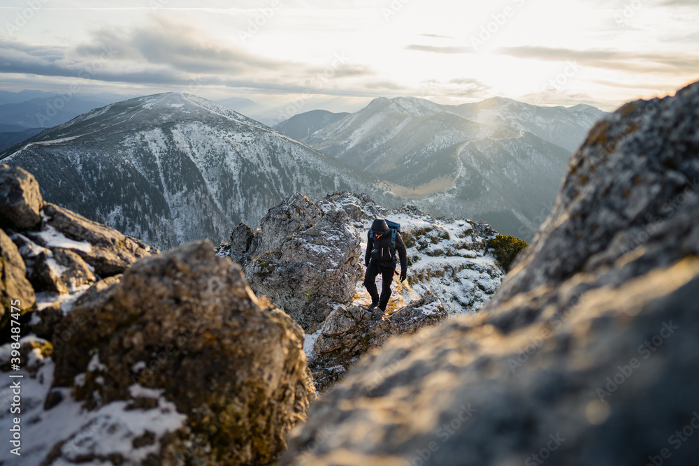 Climber or alpinist at the top of a mountain. A success of mountaineer ...