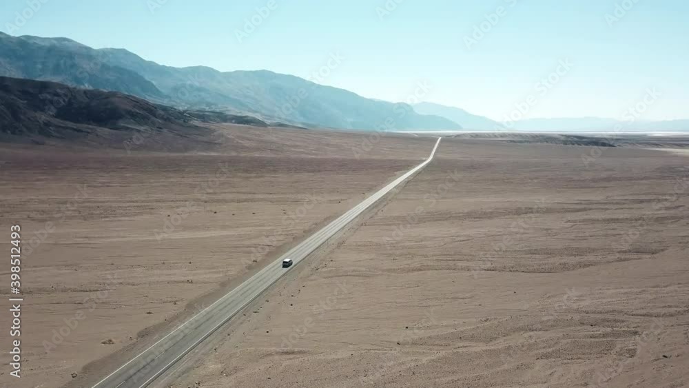 Tracking Aerial Shot Of A Car Driving On Badwater Road In Death Valley ...