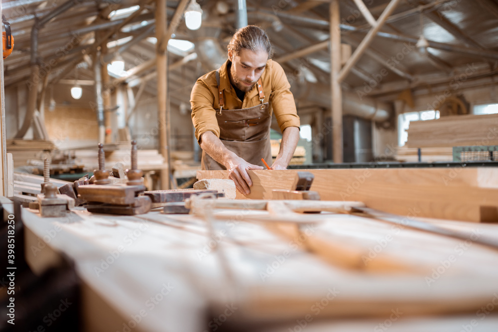 Carpenter working with a wood in the workshop Stock Photo | Adobe Stock