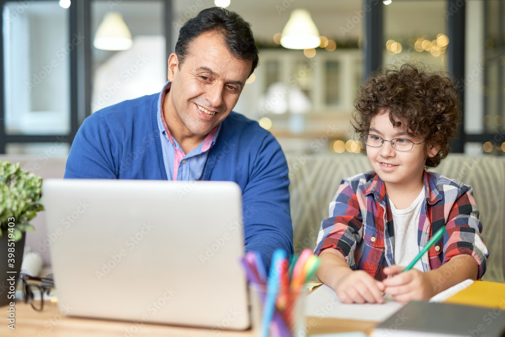 Partnership. Portrait of cheerful middle aged hispanic father spending ...