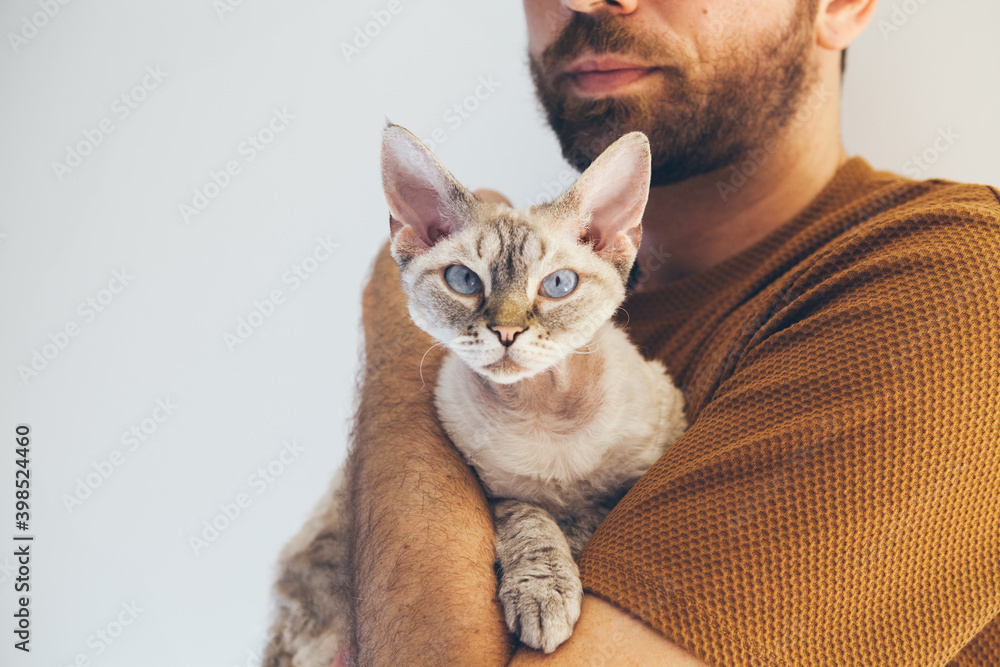 Lifestyle photo of a man hugging and touching his friendliest feline ...