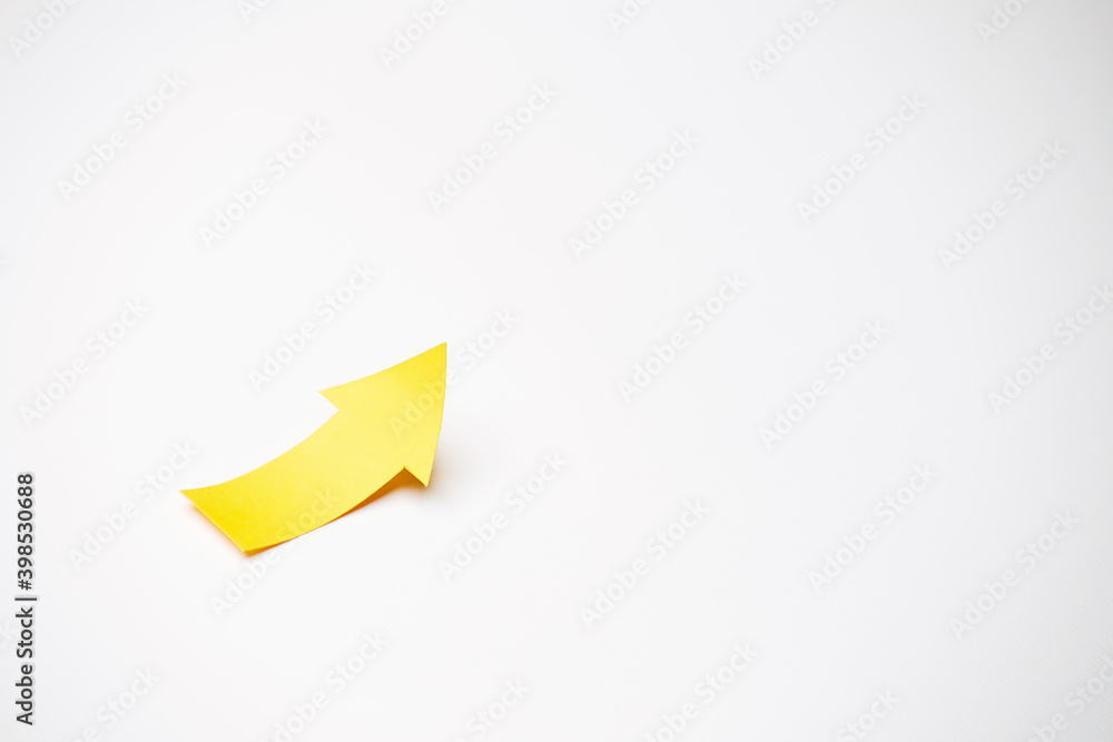 Right-up yellow paper arrow curved up of both sides which lies on the ...