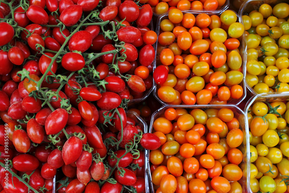 Cherry tomatoes of several varieties on the counter at the market ...