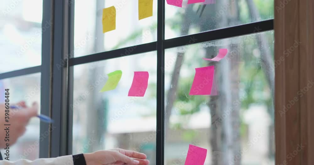 Hands close up group business meeting sticky post it colorful paper on ...